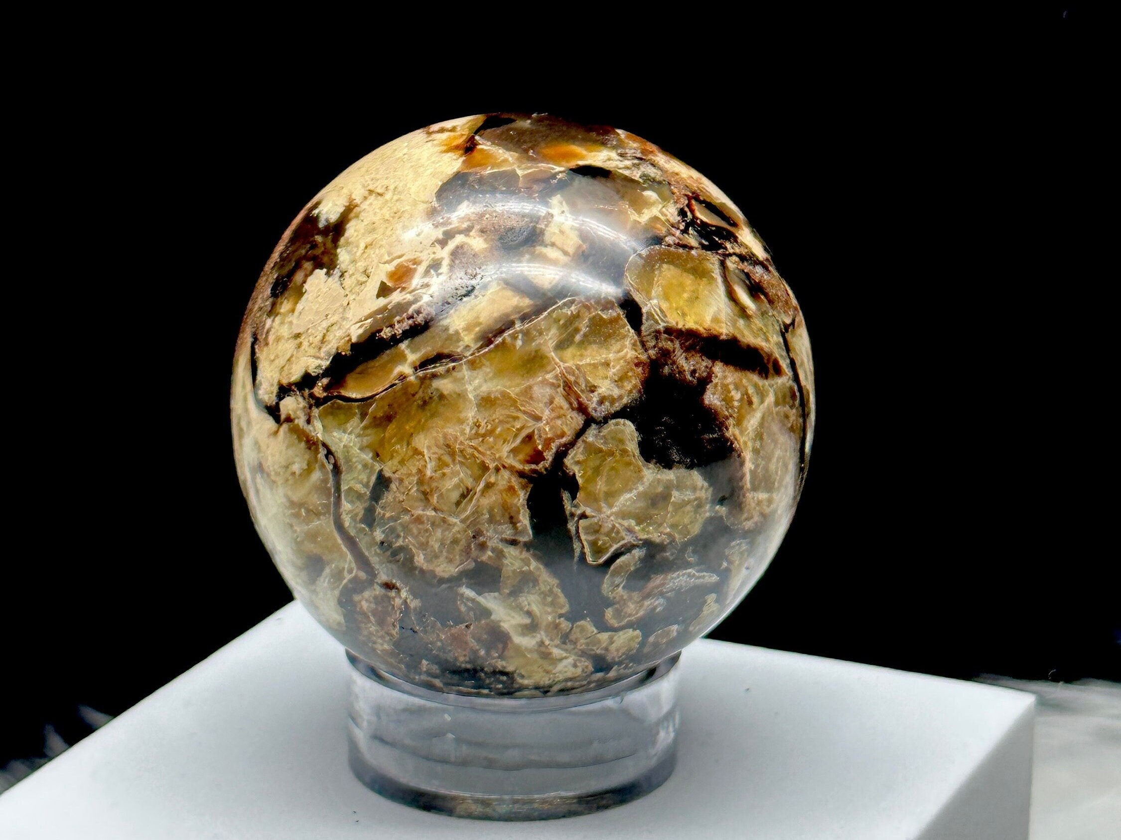Pretty banded Dominican Amber Sphere – NirViv Crystals and Jewels